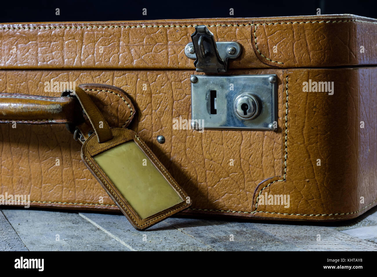 Old stylish suitcase. Lock with the key in the bag. Suitcase on a ...