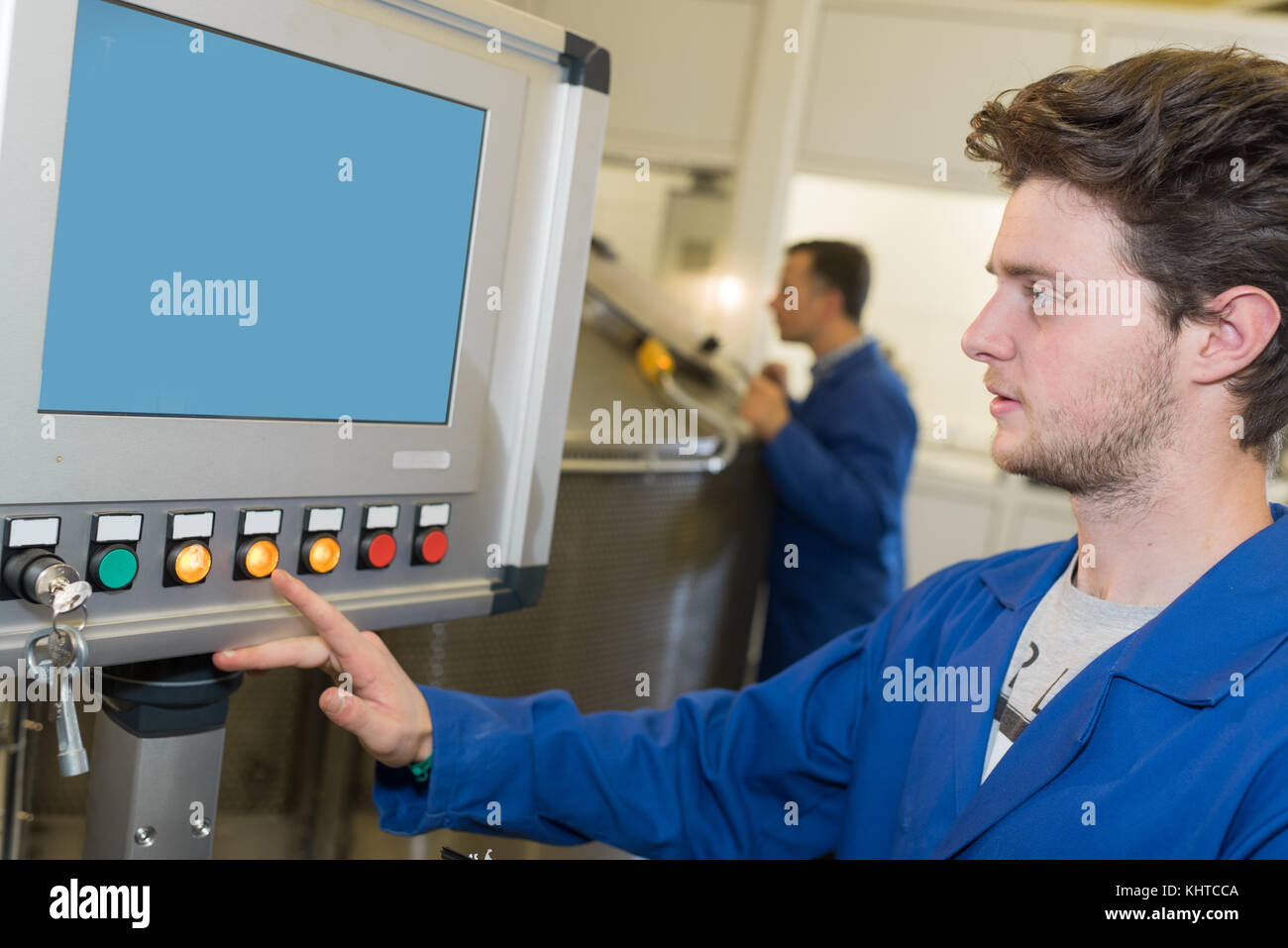 worker operating a machine in a factory Stock Photo - Alamy
