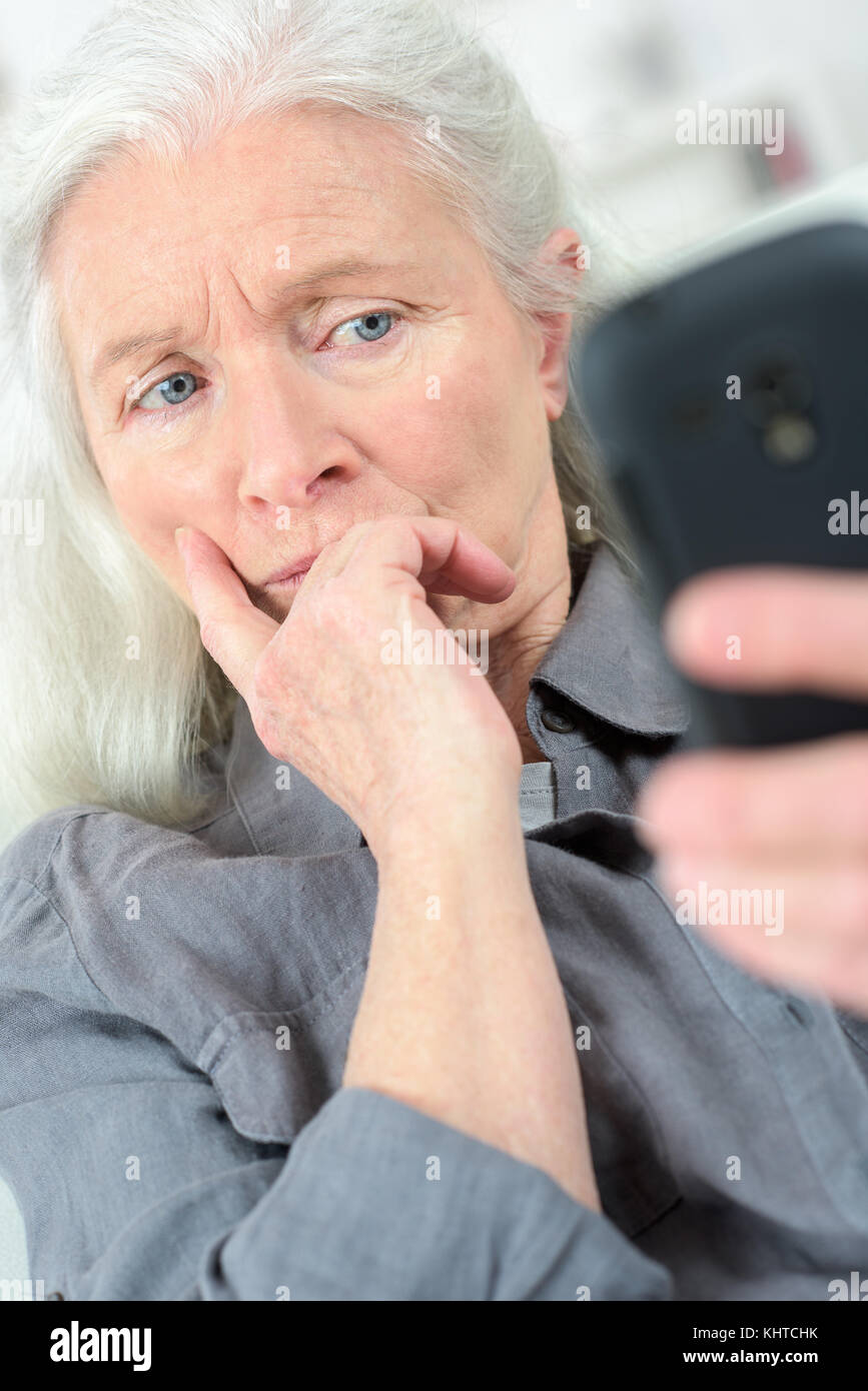 Senior lady reading a text message Stock Photo - Alamy