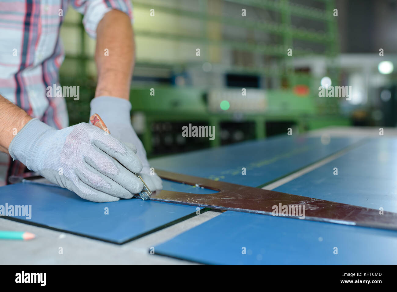 Hands scoring line on metal Stock Photo - Alamy