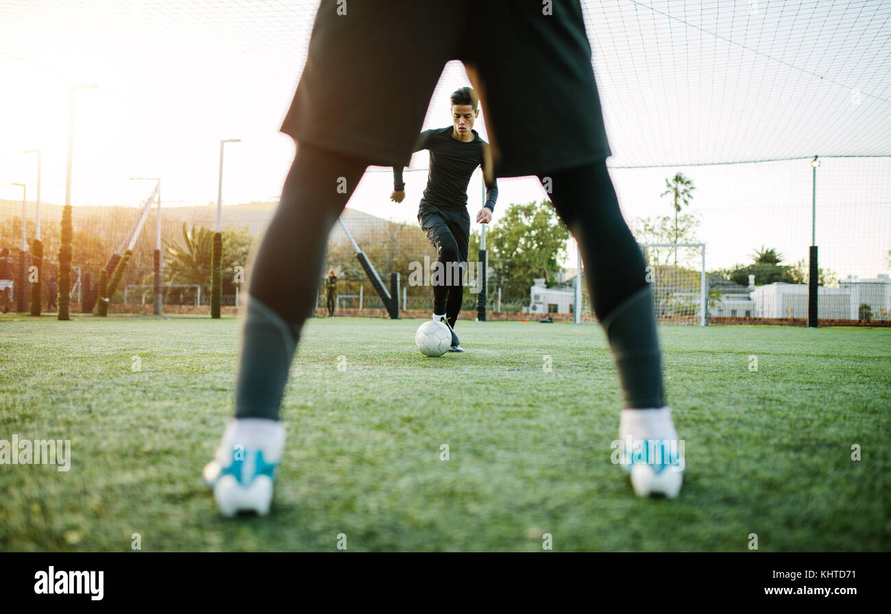 Soccer players during team practice in field. Young footballer playing ...