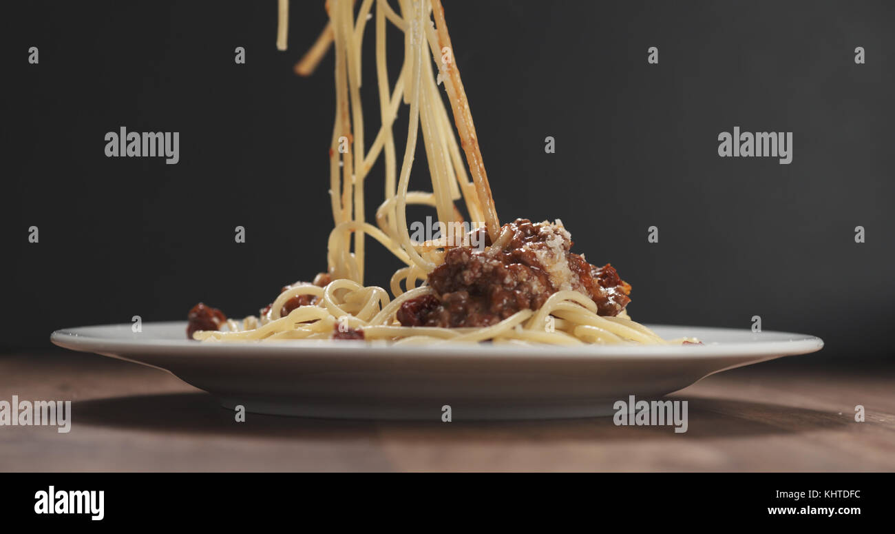 eating spaghetti with bolognese sauce with fork, wide photo Stock Photo ...