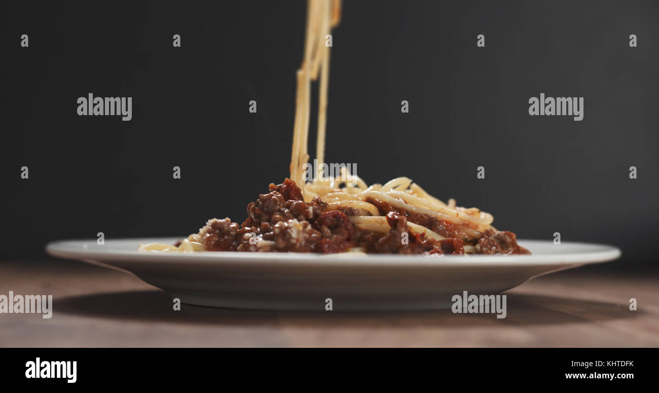 eating spaghetti with bolognese sauce with fork, wide photo Stock Photo ...