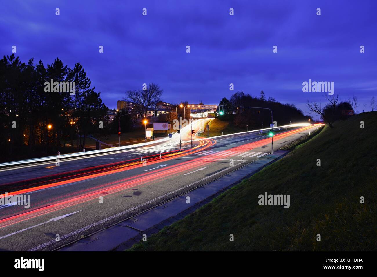 Night photo traffic on the road. Evening landscape with cars. Cars with ...