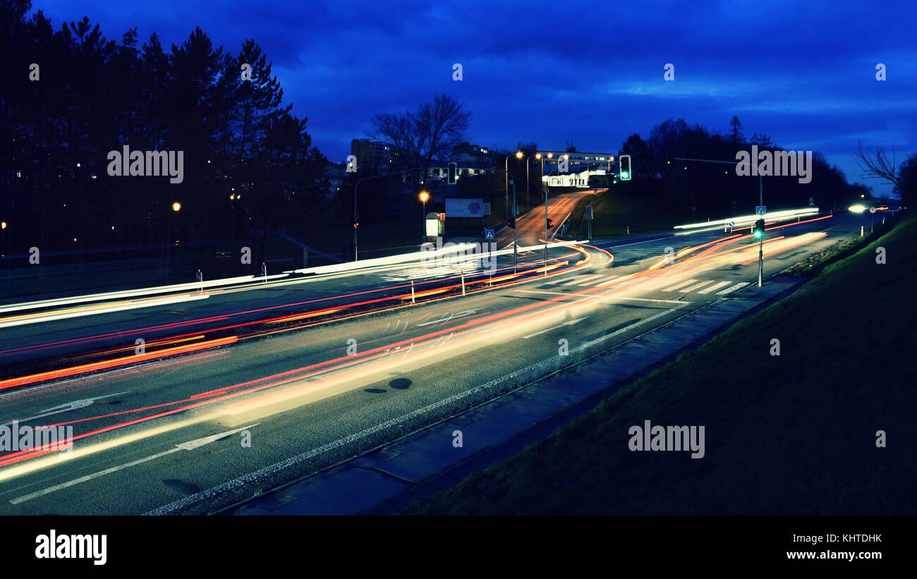 Night photo traffic on the road. Evening landscape with cars. Cars with ...