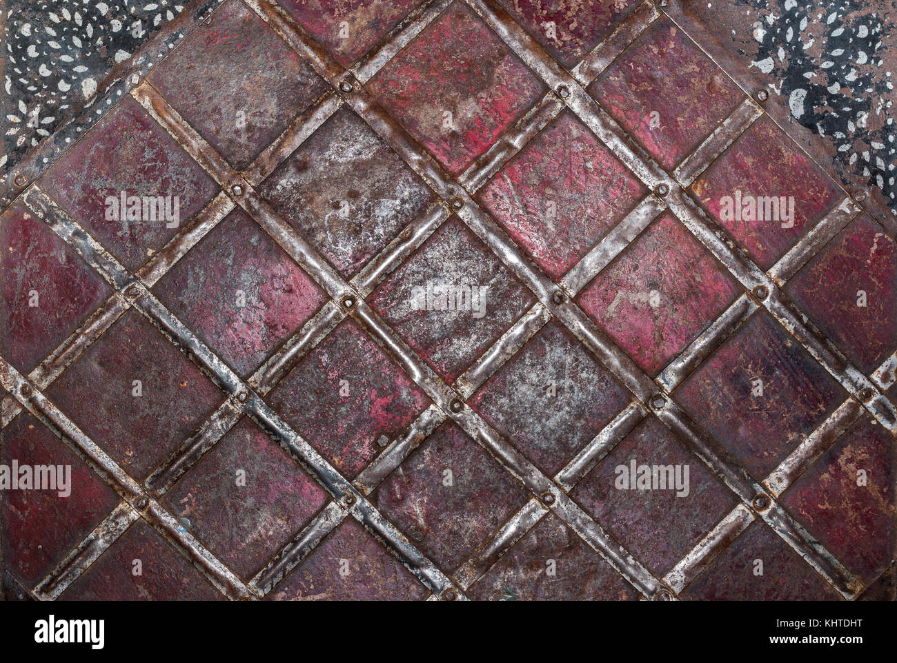 Geometric pattern of tin strips nailed to rusty metal sheet, painted in ...