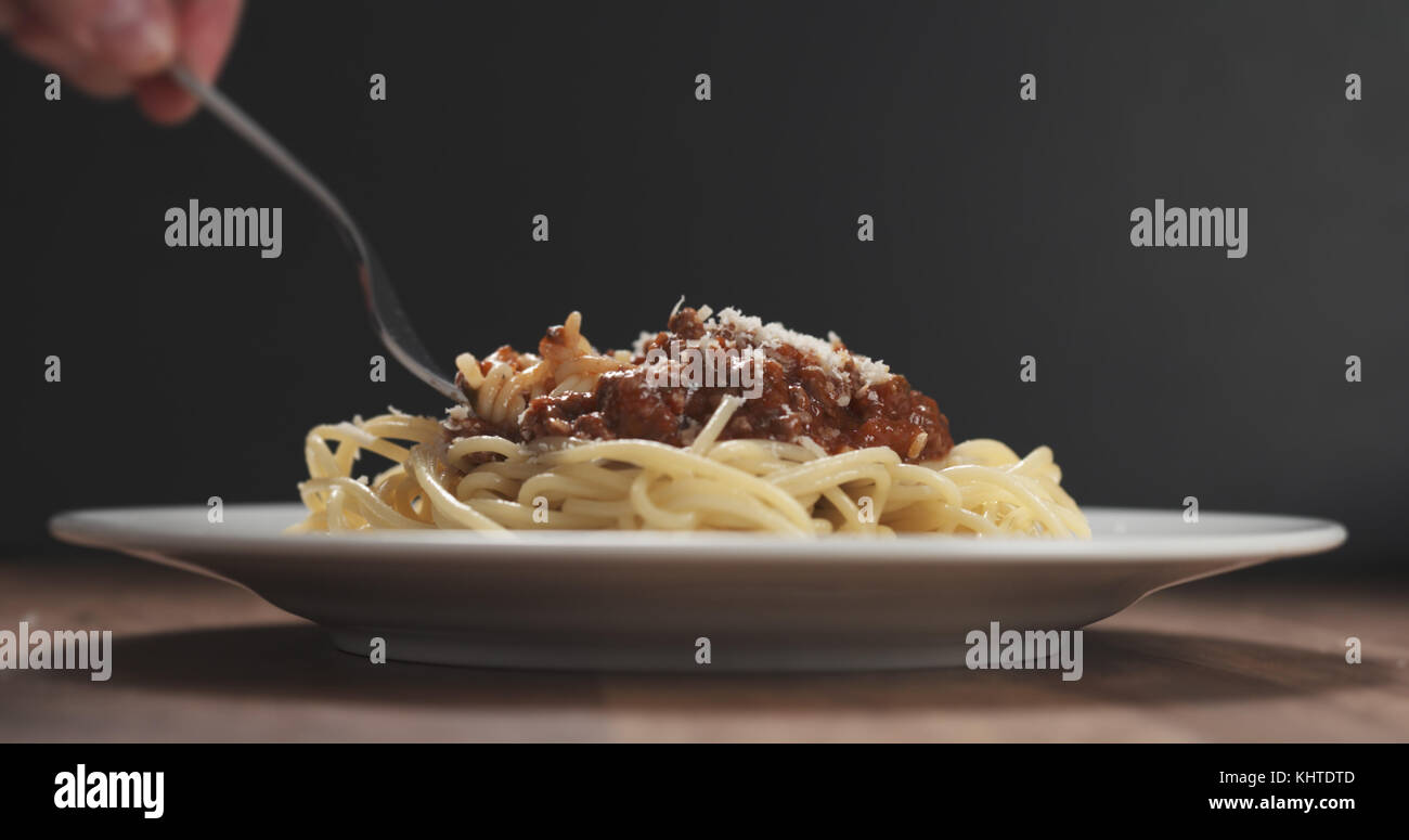 eating spaghetti with bolognese sauce with fork Stock Photo - Alamy