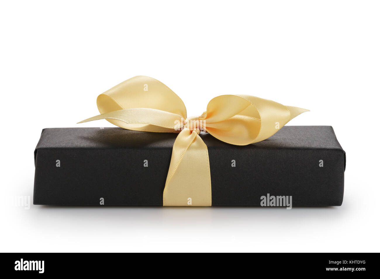 black gift box with golden ribbon bow isolated on white Stock Photo - Alamy