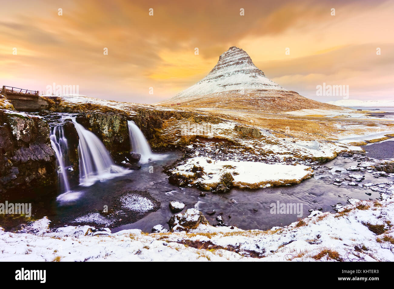 View of the Kirkjufell Mountain with Kirkjufellsfoss Waterfall at dusk ...