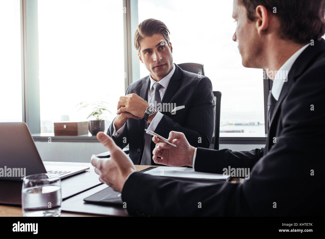 businessman listening to his partner during a strategy meeting ...