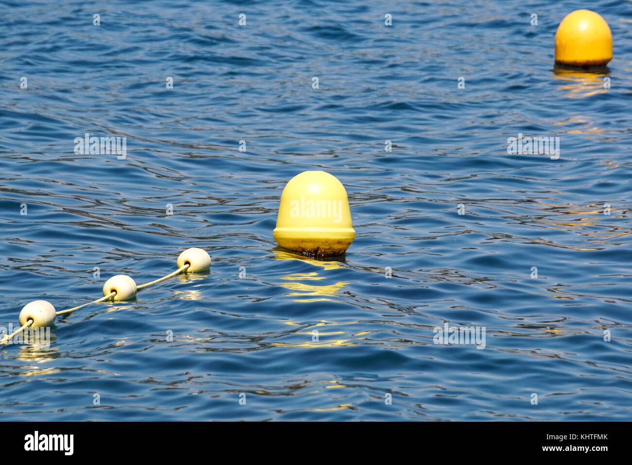 Line of yellow buoys against the blue sea. Restriction on open water ...