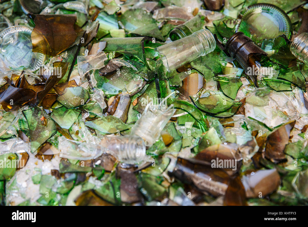Shards of glass bottles green, scattered on the white surface ...