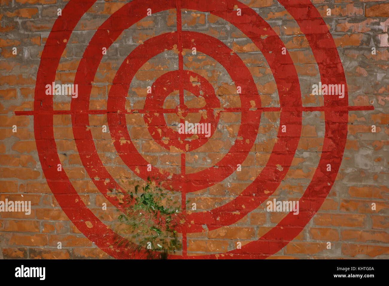 Red Target on the red brick wall. Graffiti. They hit the target with a ...