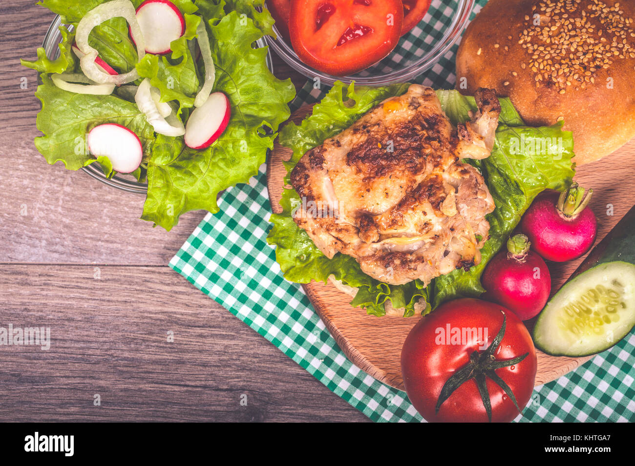 Preparing delicious homemade chicken burger with fresh lettuce ...
