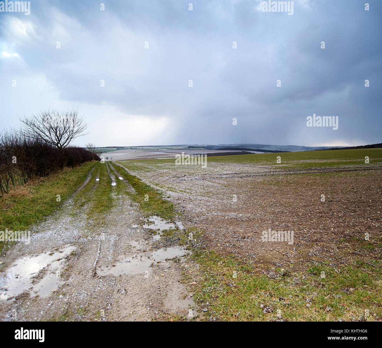 Field landscape in winter with cloudburst over distant hills, Yorkshire ...