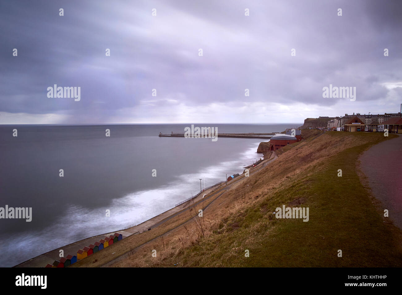 Distant view of Whitby coastline and harbour from cliff top, North ...