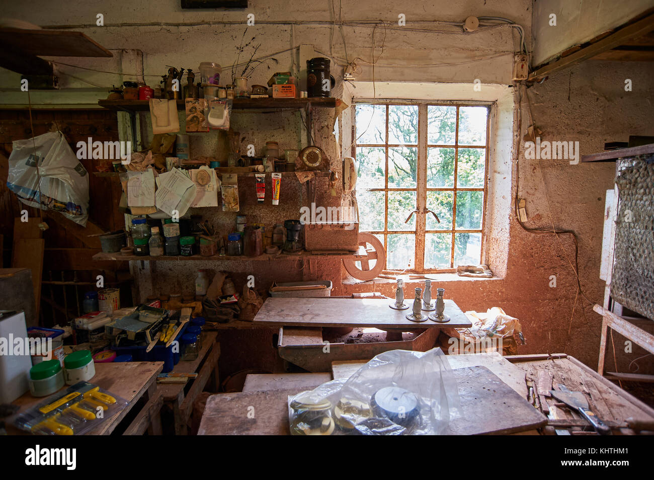 Cluttered work bench and shelving in pottery studio, Longsleddale ...