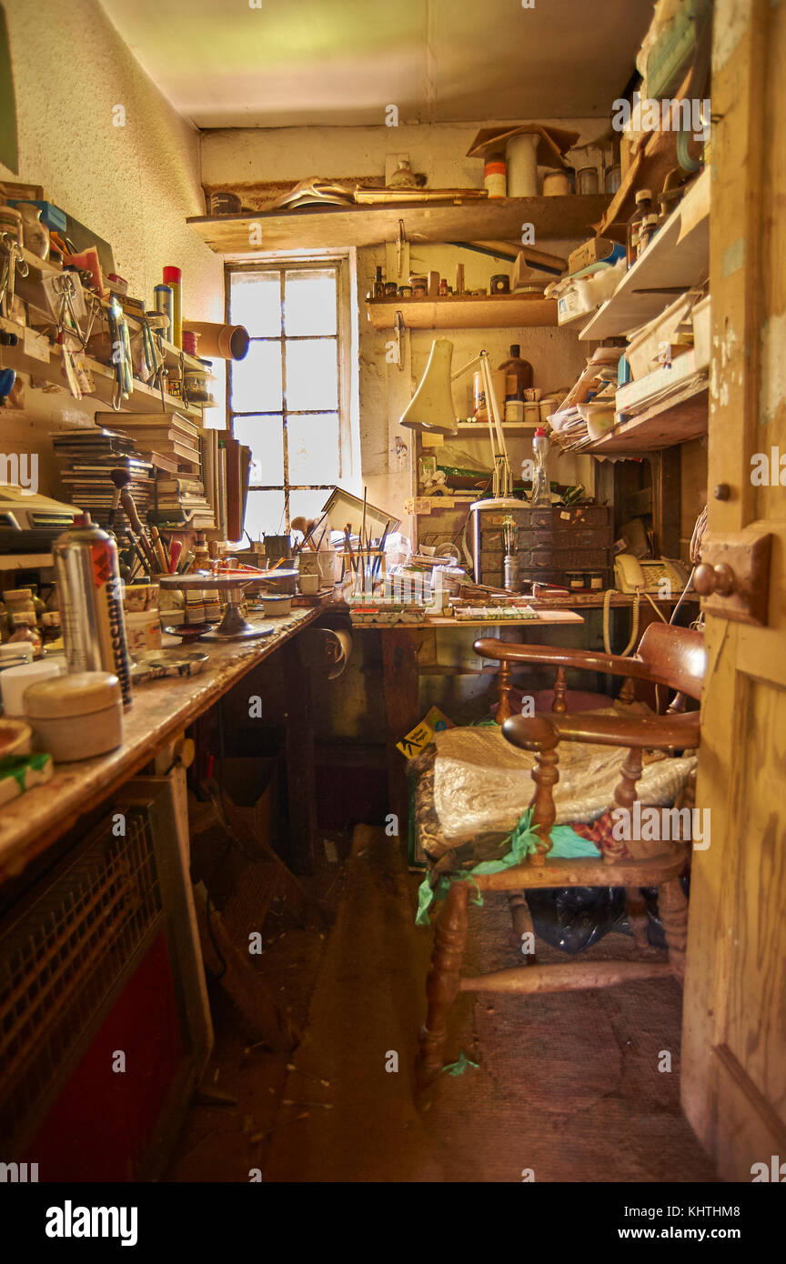 Cluttered shelves and work bench in pottery studio workshop ...