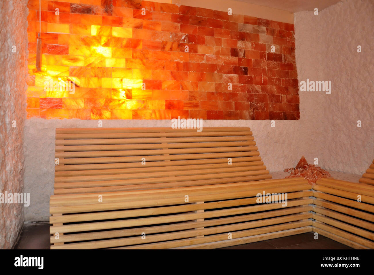 Wooden bench salt wall and headrest support in sauna room as relaxation ...
