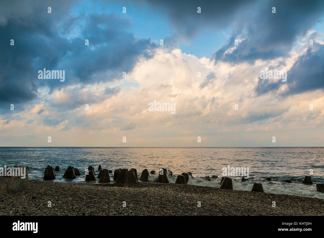 Seascape with the sea surf breaking on the concrete conical boulders ...