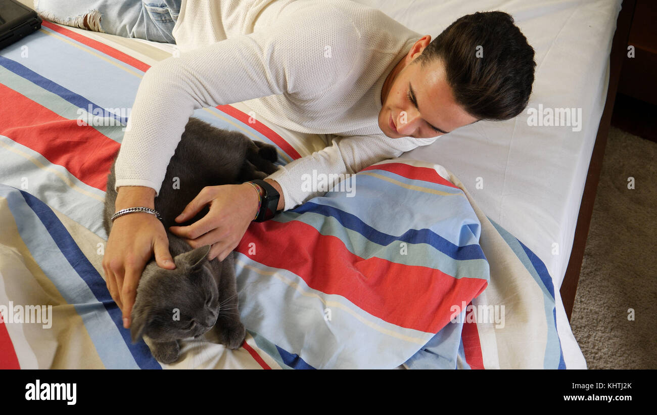 Young guy holding a kitten hi-res stock photography and images - Alamy