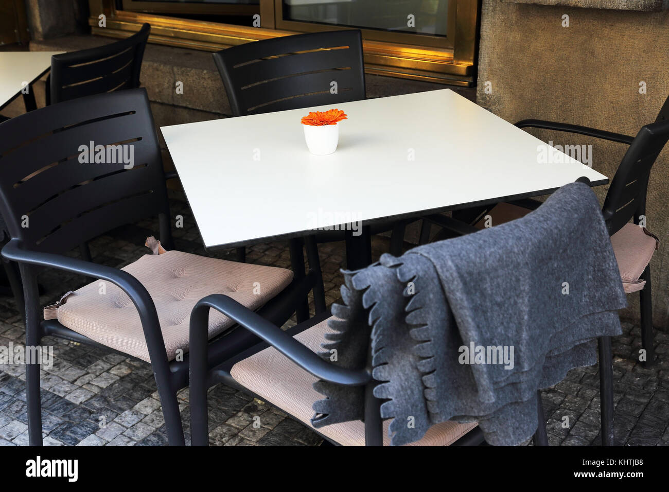 restaurant, table and four chairs on the street Stock Photo - Alamy