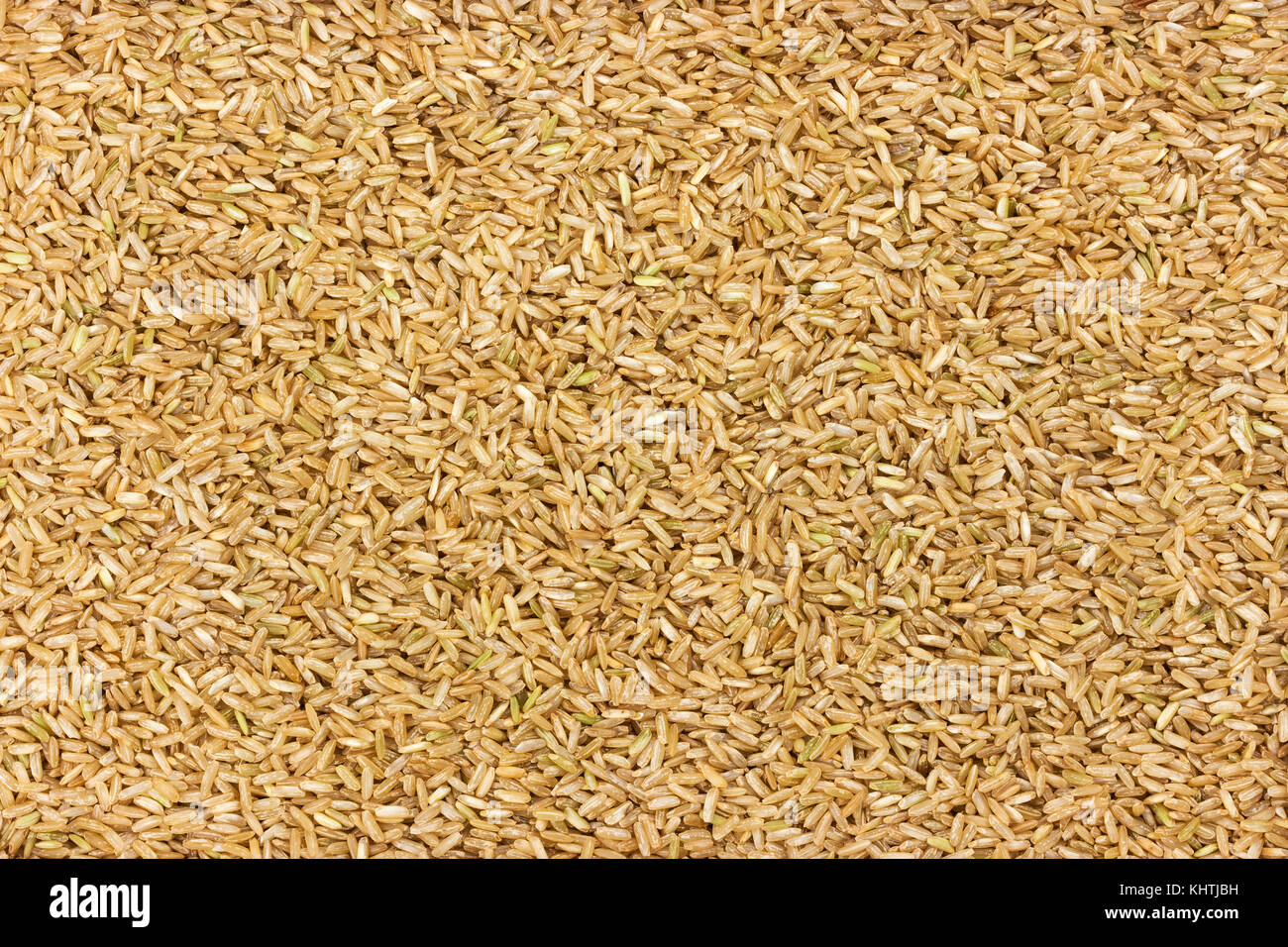 Brown rice groats background, untreated rice texture Stock Photo - Alamy
