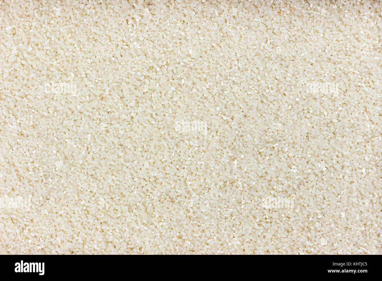 Small crushed rice background or texture Stock Photo - Alamy