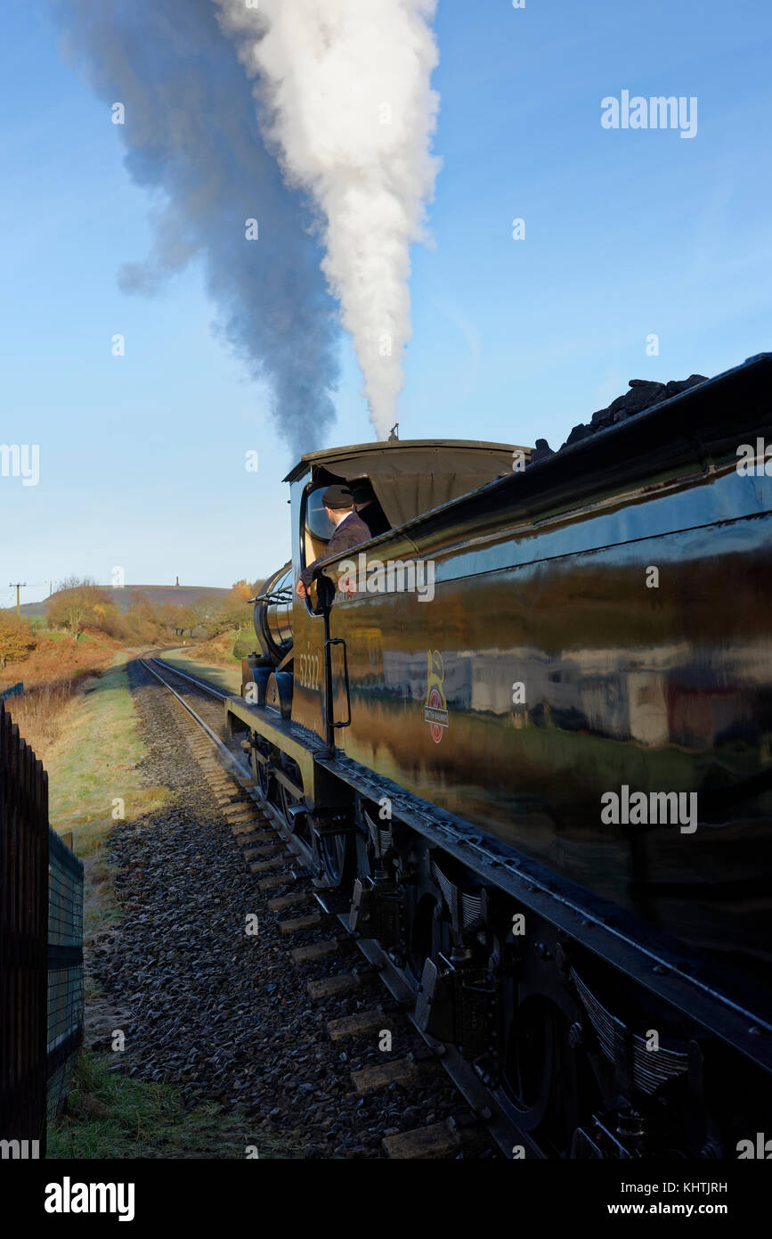 Black steam locomotive and tender waiting to depart from burrs country ...