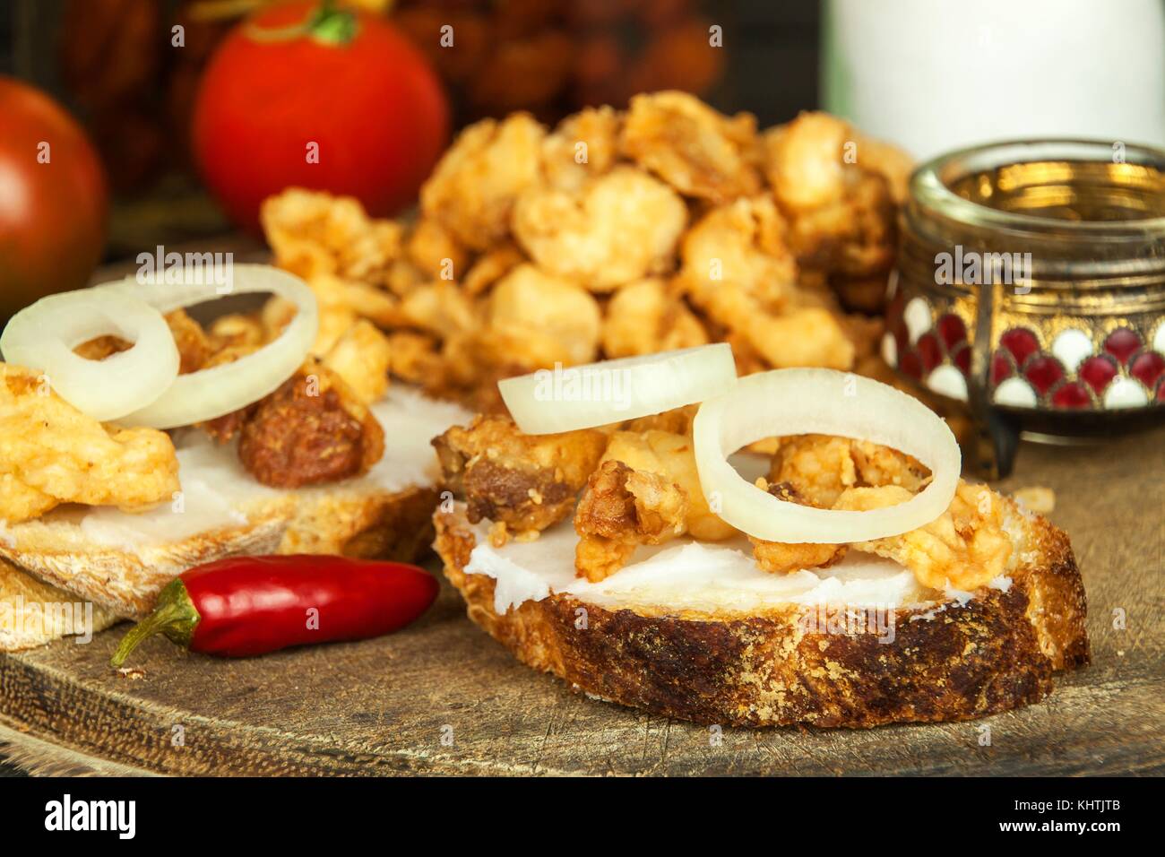 Heap of domestic salty fried pork greaves. Fatty junk food. Pork ...
