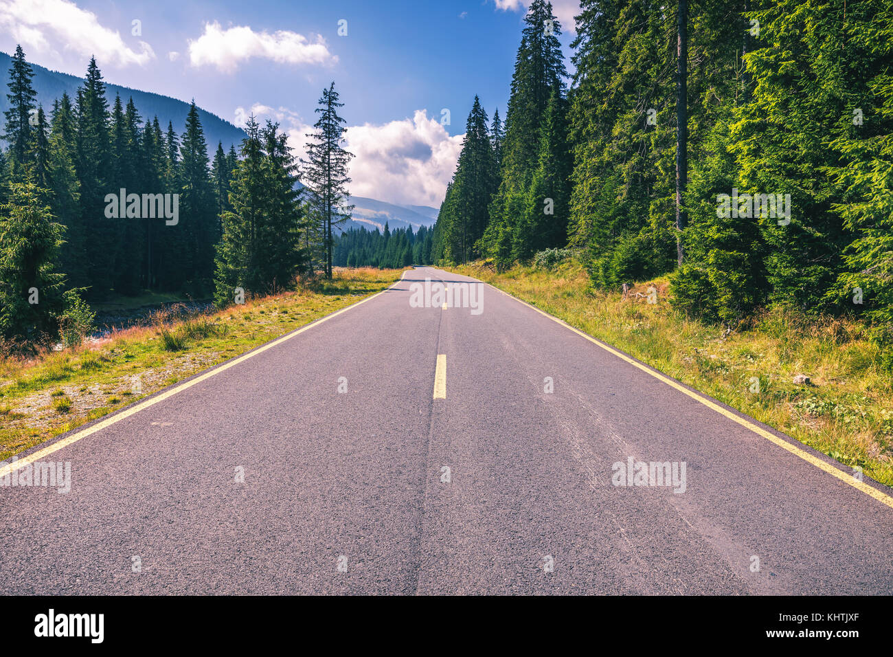 Mountain road. Landscape with rocks, sunny sky with clouds and ...