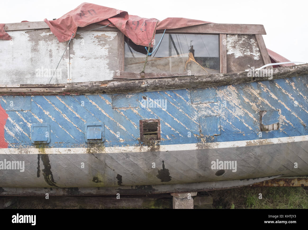 Side view of an old boat with flaking paintwork at Kingholm Quay ...
