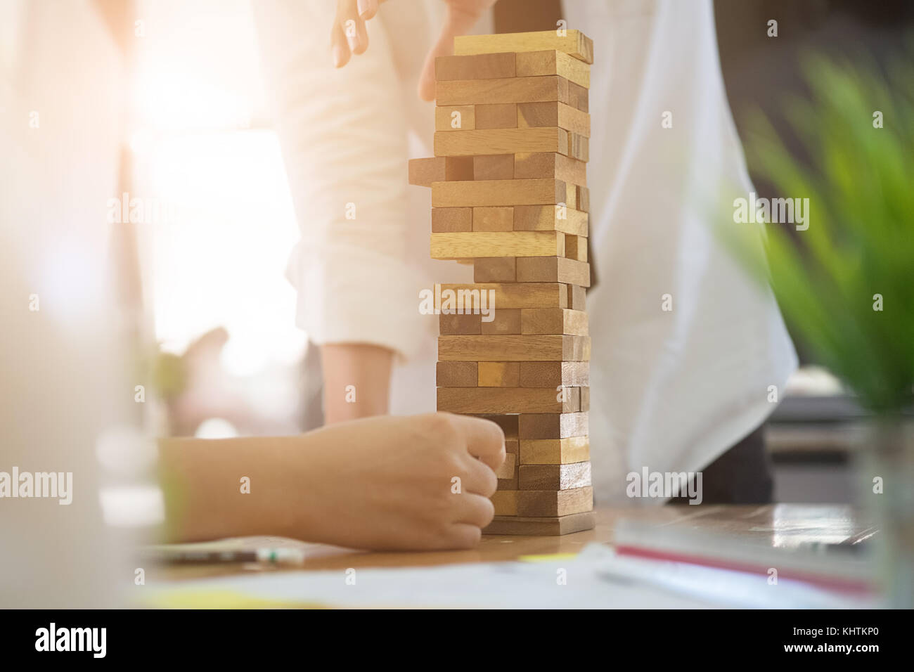 business persons planning a project brown wood building block tower ...