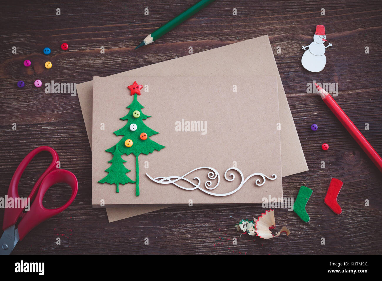 Signing Christmas card with felt Christmas-tree, snowflakes effect and ...