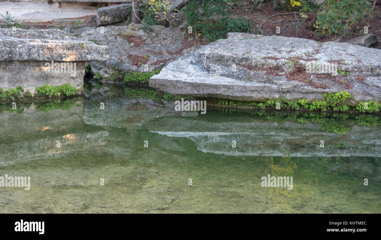 Large Rock Reflected on Calm Spring Water Stock Photo - Alamy