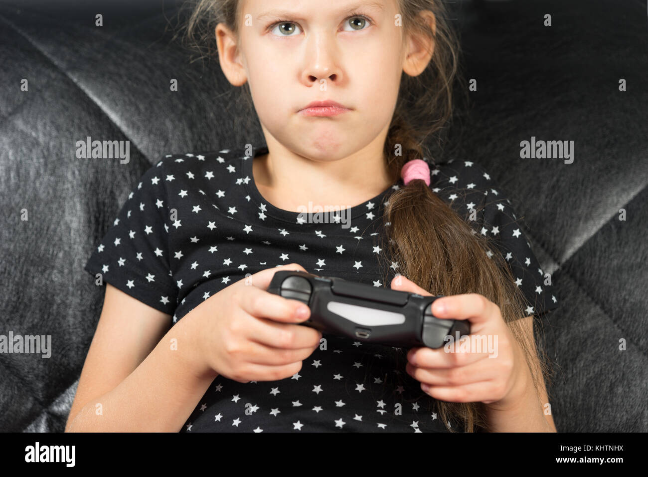 Child playing video games and holds joystick or controller Stock Photo ...