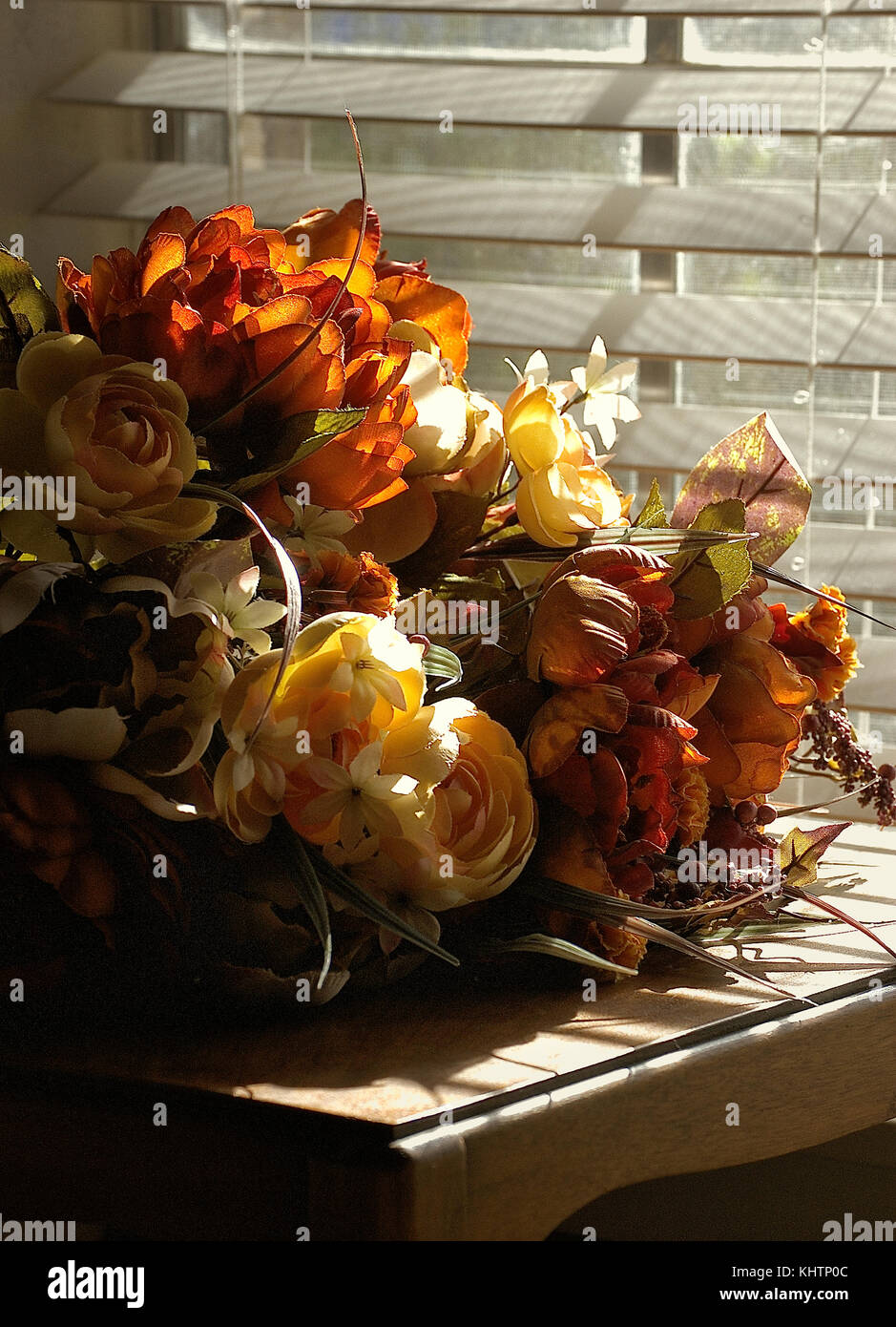 Flower bouquet by a window with shades and afternoon shadows Stock ...