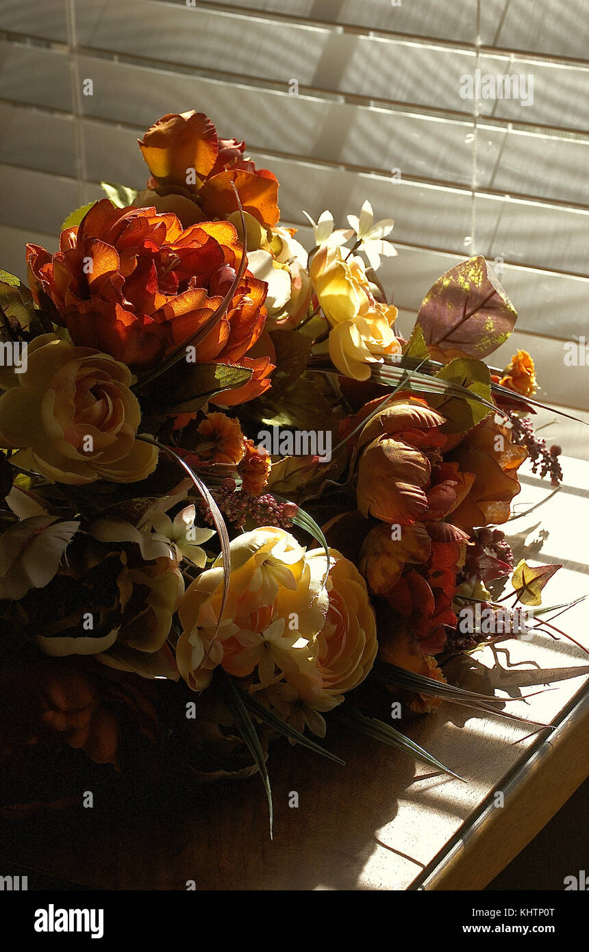 Flower bouquet by a window with shades and afternoon shadows Stock ...