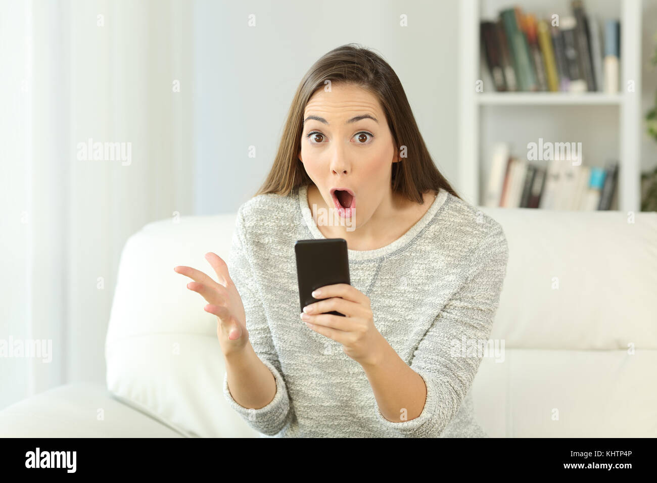 Woman holding phone happy reaction hi-res stock photography and images ...
