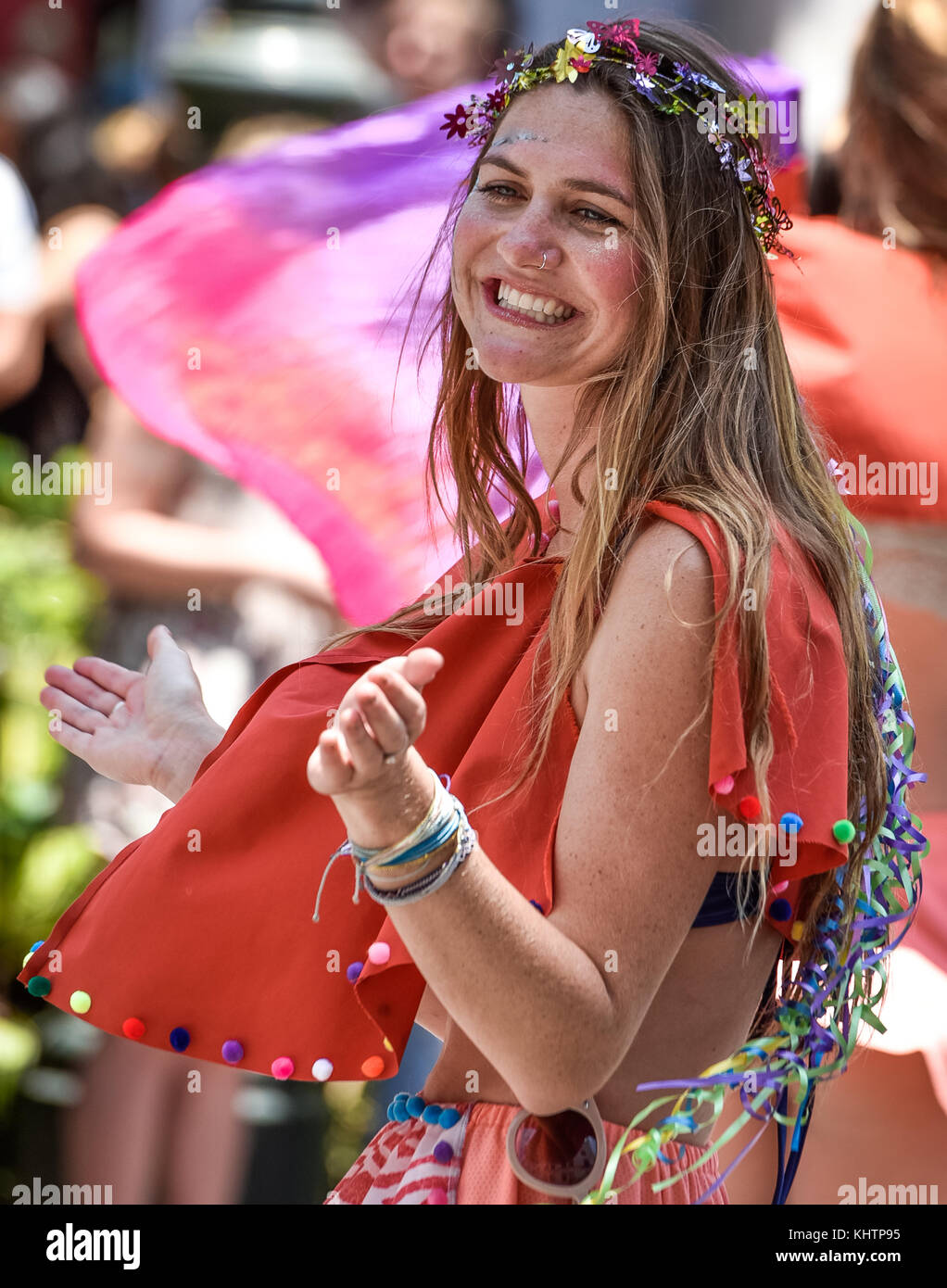 A young woman dancing and laughing at the annual Summer Solstice Parade ...