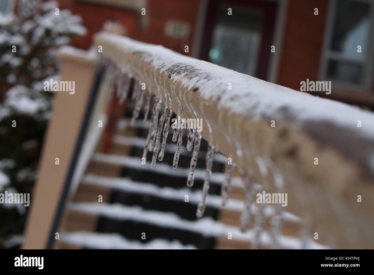 Icicles hanging from a front porch stair rail, after the first ice rain ...