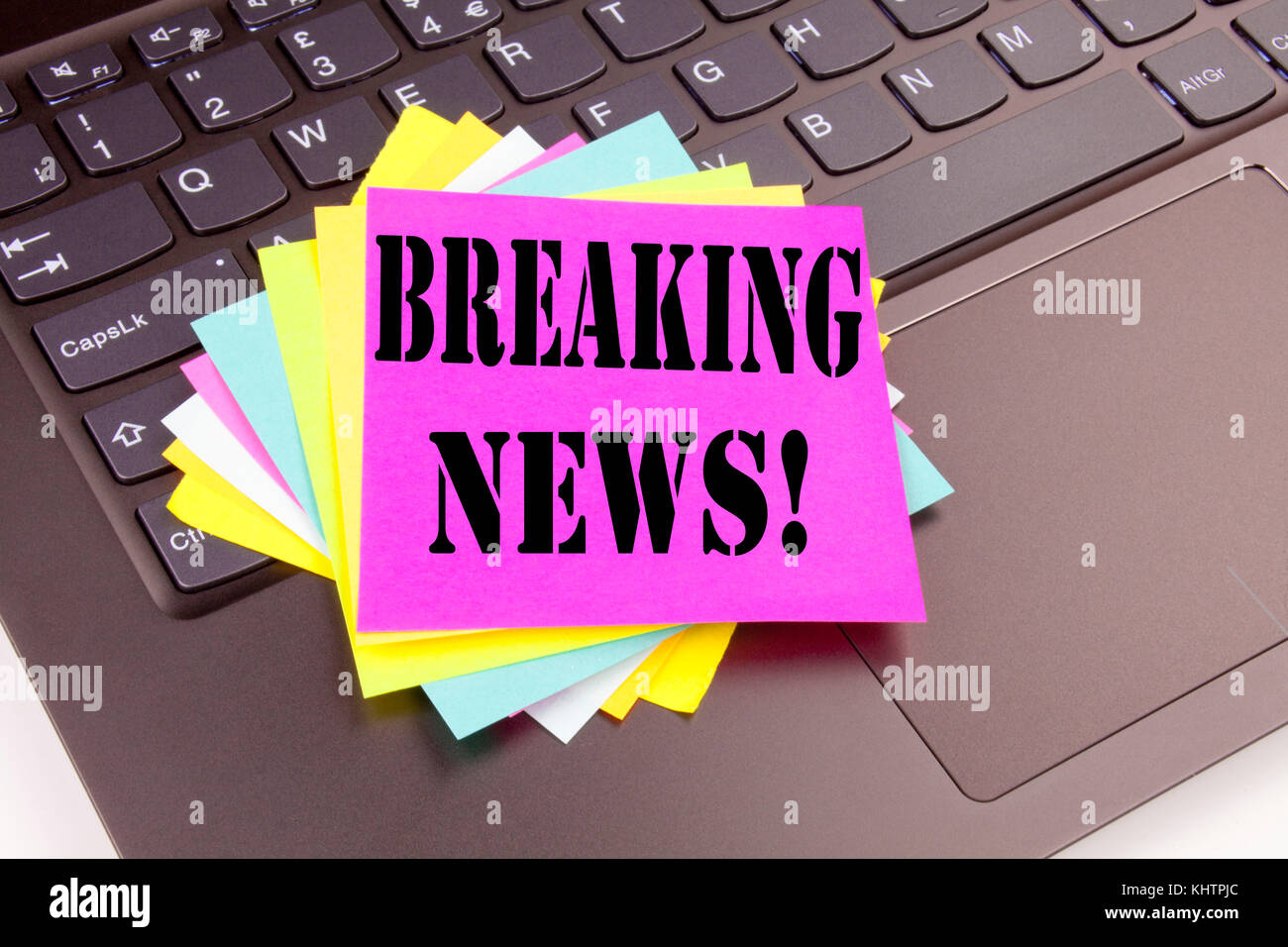 Writing Breaking News text made in the office close-up on laptop ...