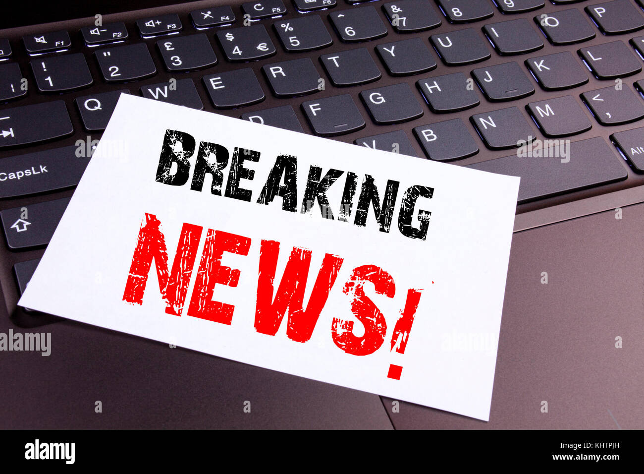 Writing Breaking News text made in the office close-up on laptop ...