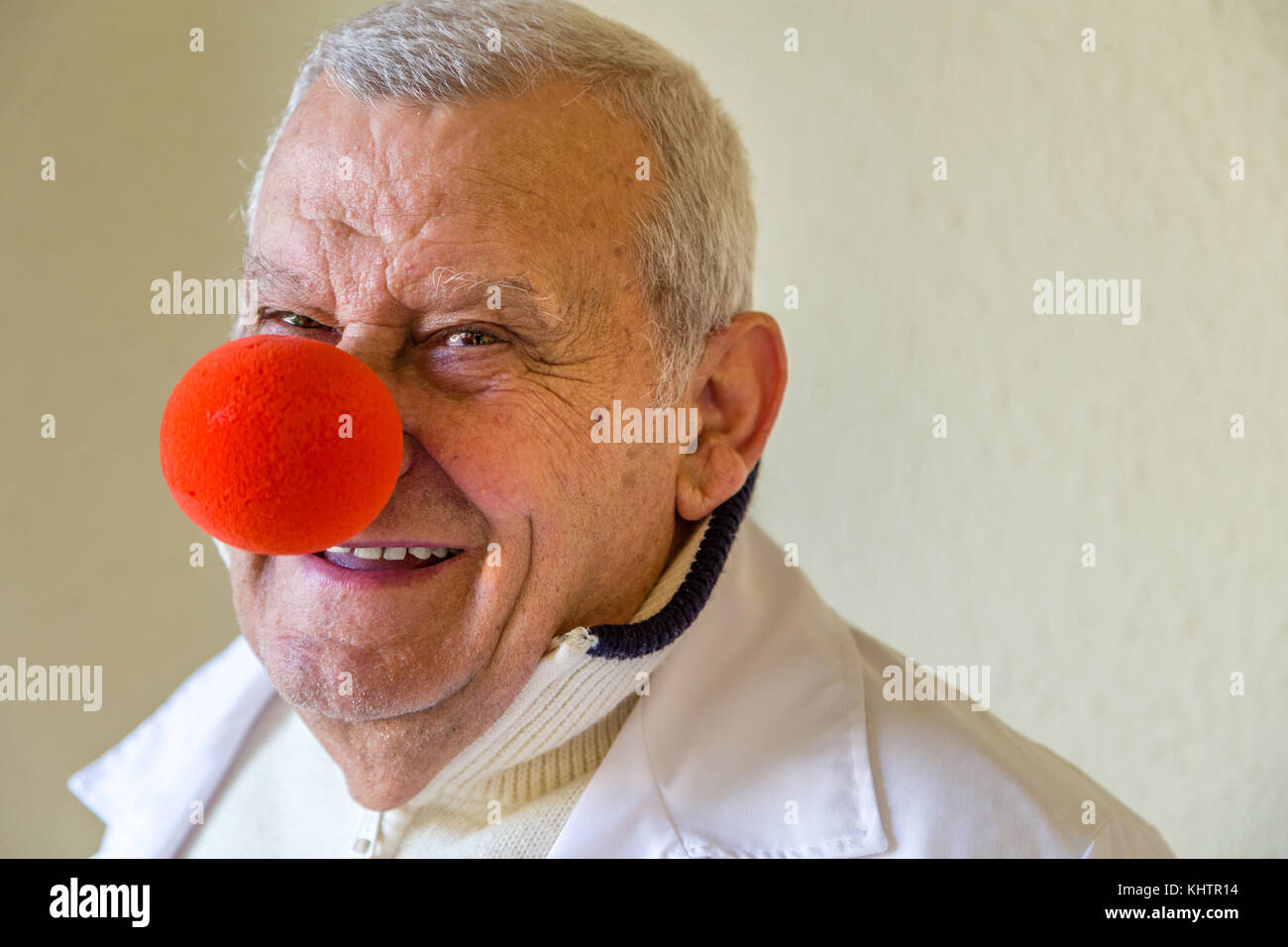 old country doctor with clown red nose smiling Stock Photo - Alamy