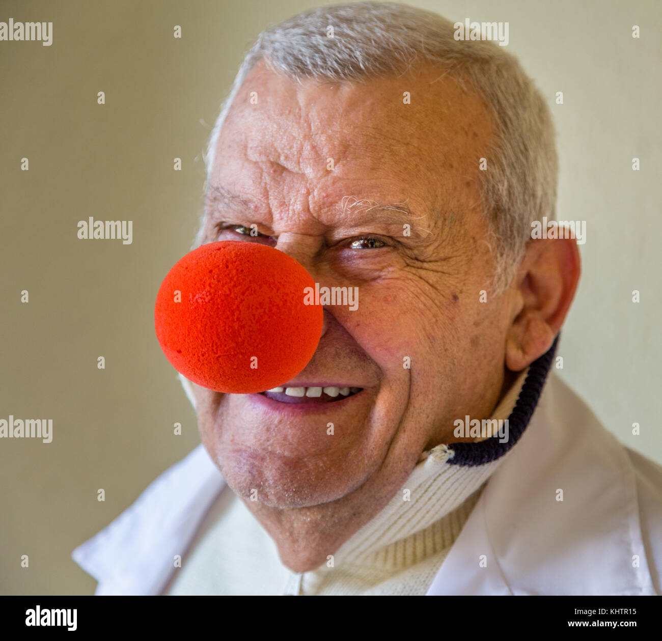 old country doctor with clown red nose smiling Stock Photo - Alamy