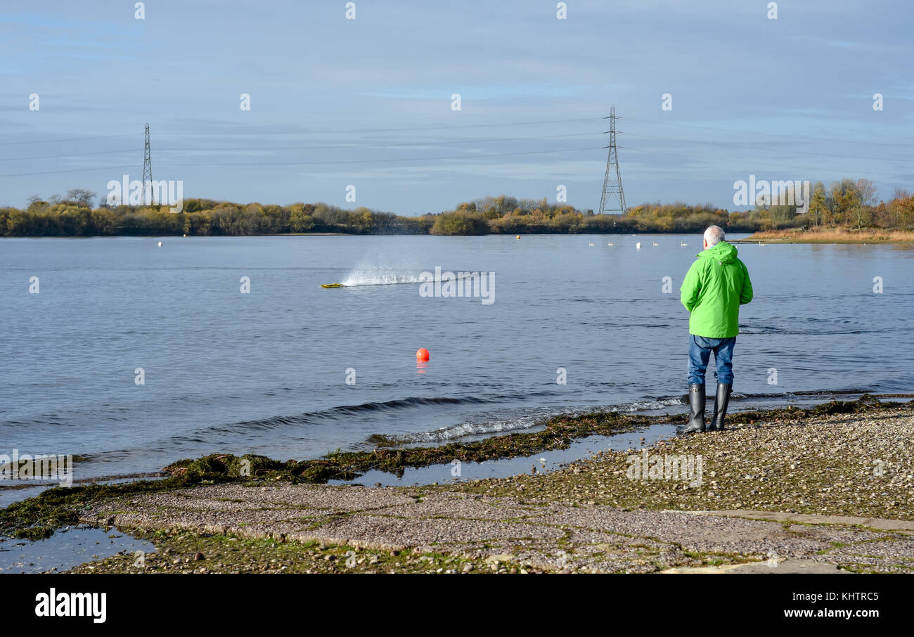 Man playing with a remote control boat on Chasewater Country Park lake ...