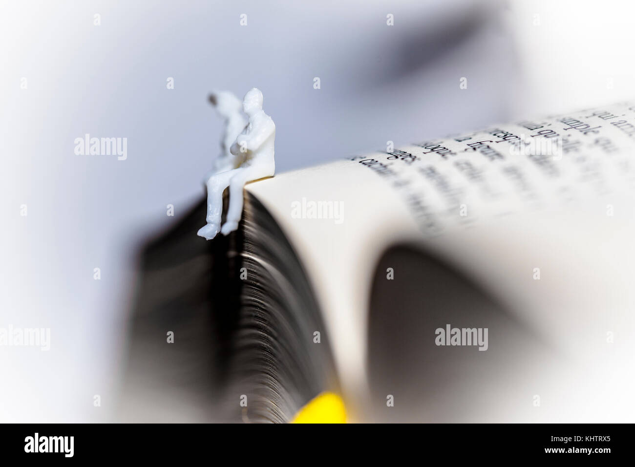 miniature people figures sitting on an open book Stock Photo - Alamy