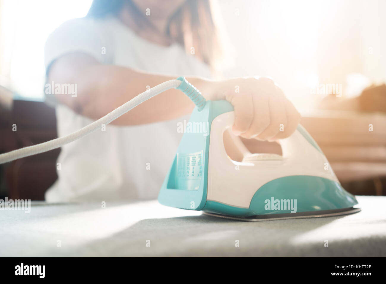 asian woman ironing clothes on ironing board Stock Photo - Alamy