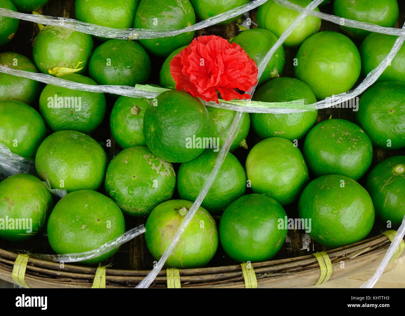 Green lemon fruits for sale at local market in Bangkok, Thailand Stock ...