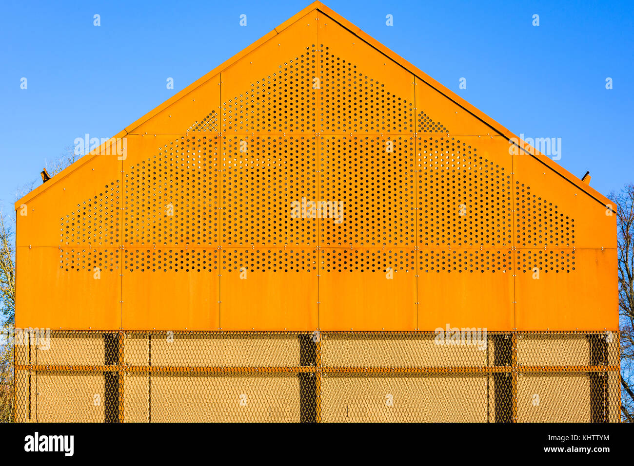 Rusty iron gable with holes. Netted wall Stock Photo - Alamy